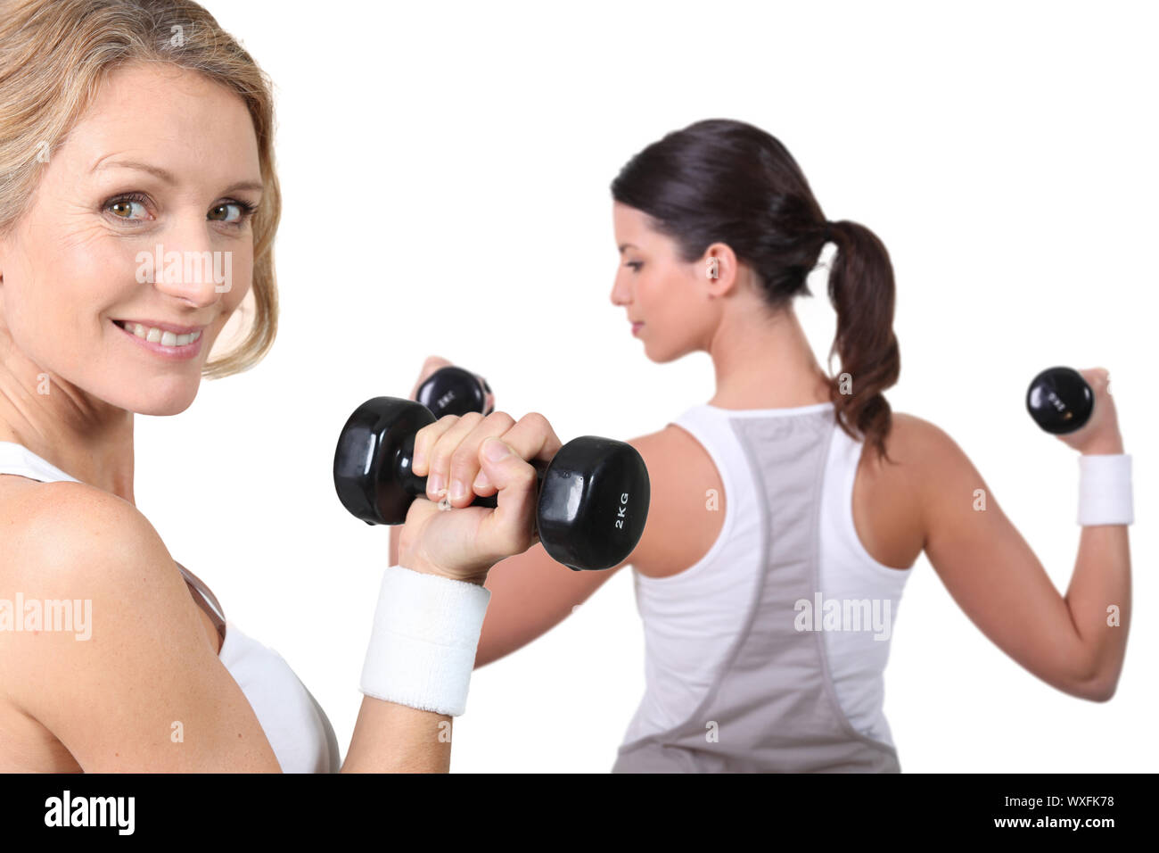 Women lifting weights together Stock Photo - Alamy