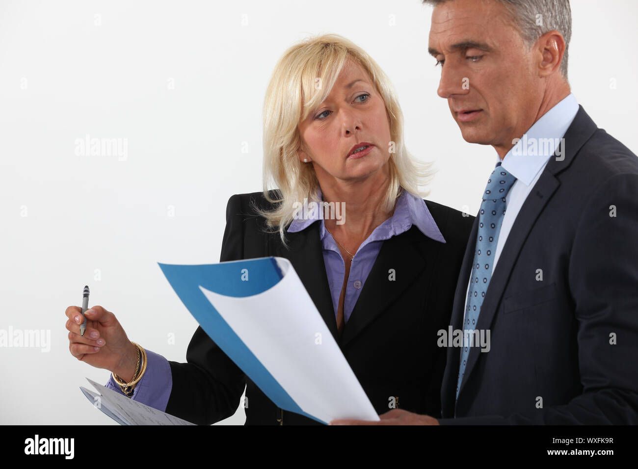 Experienced businessman people reviewing document Stock Photo - Alamy