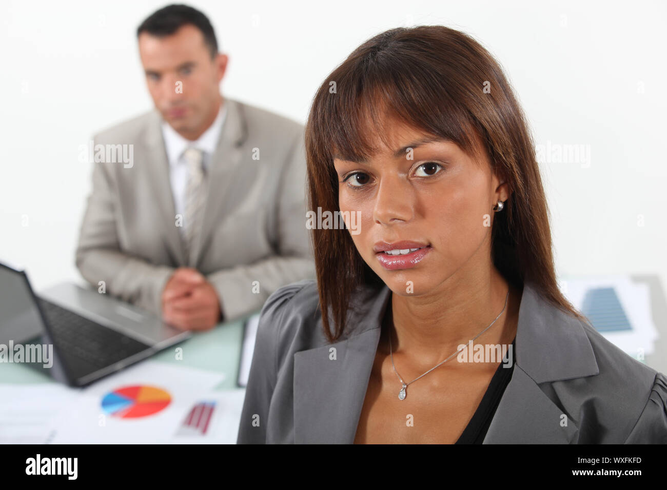 Two business people working on statistical data Stock Photo - Alamy