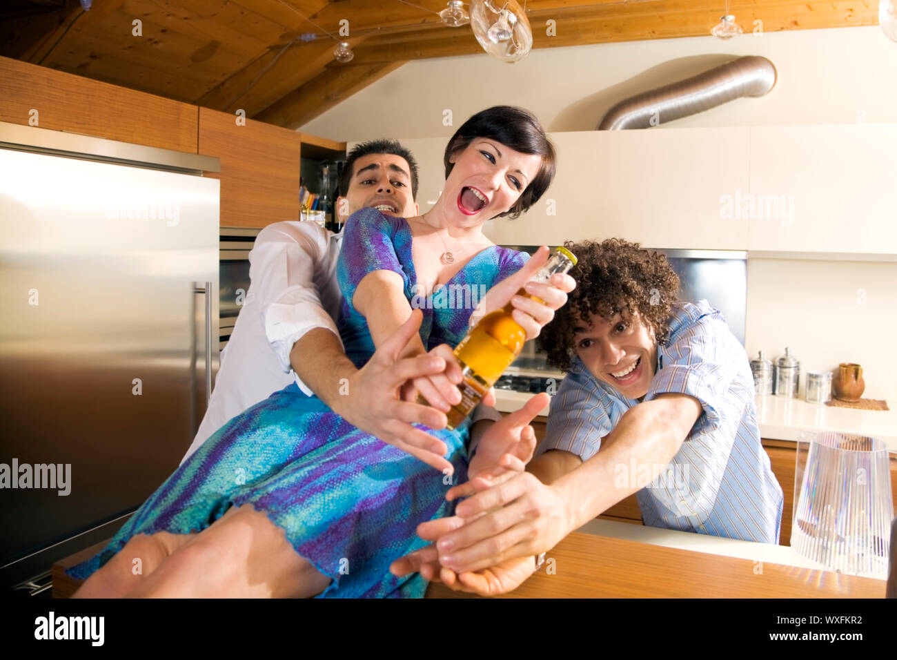 domestic life: friends competing for the last beer Stock Photo - Alamy