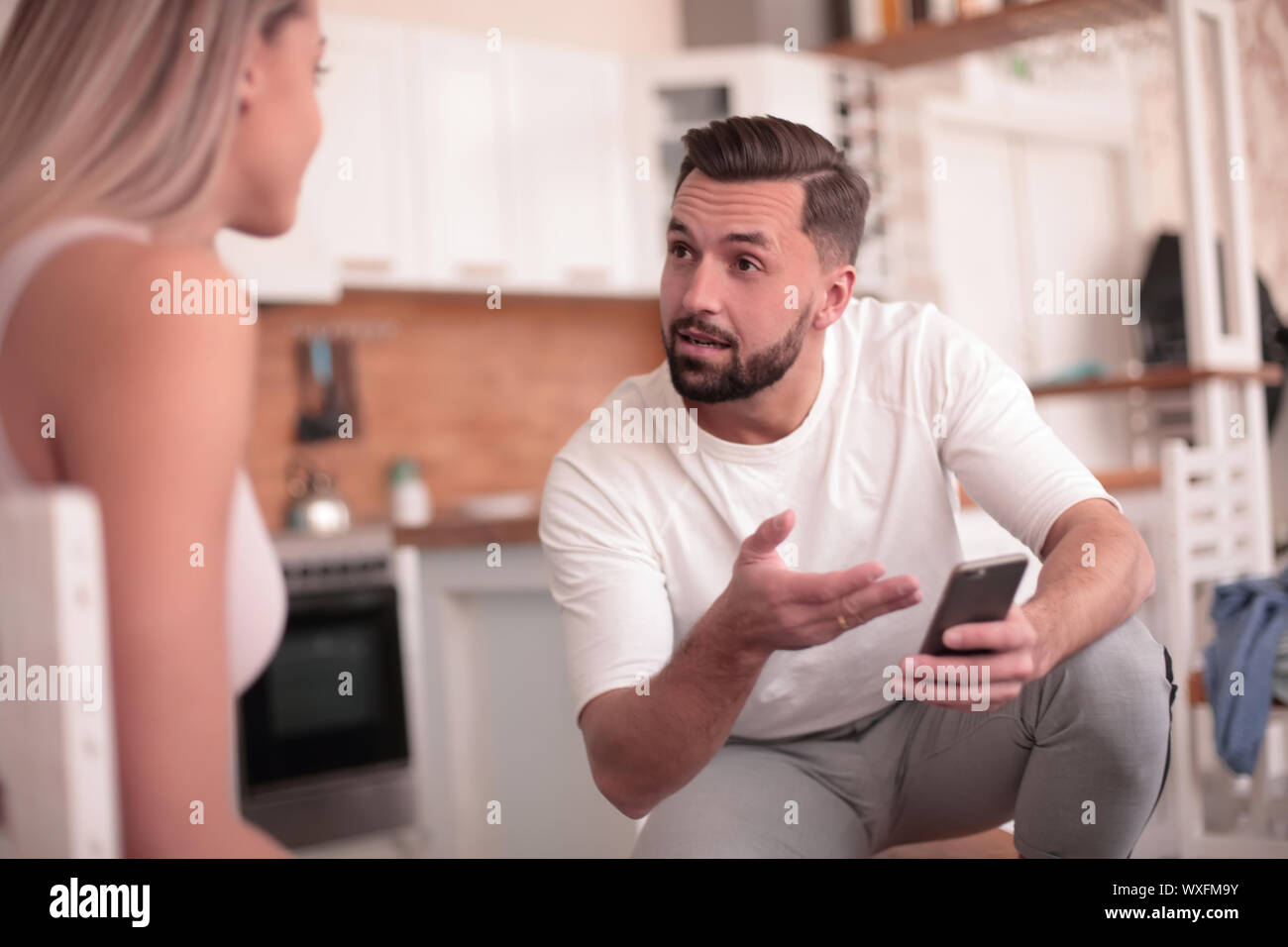 young man explaining something to his wife Stock Photo - Alamy