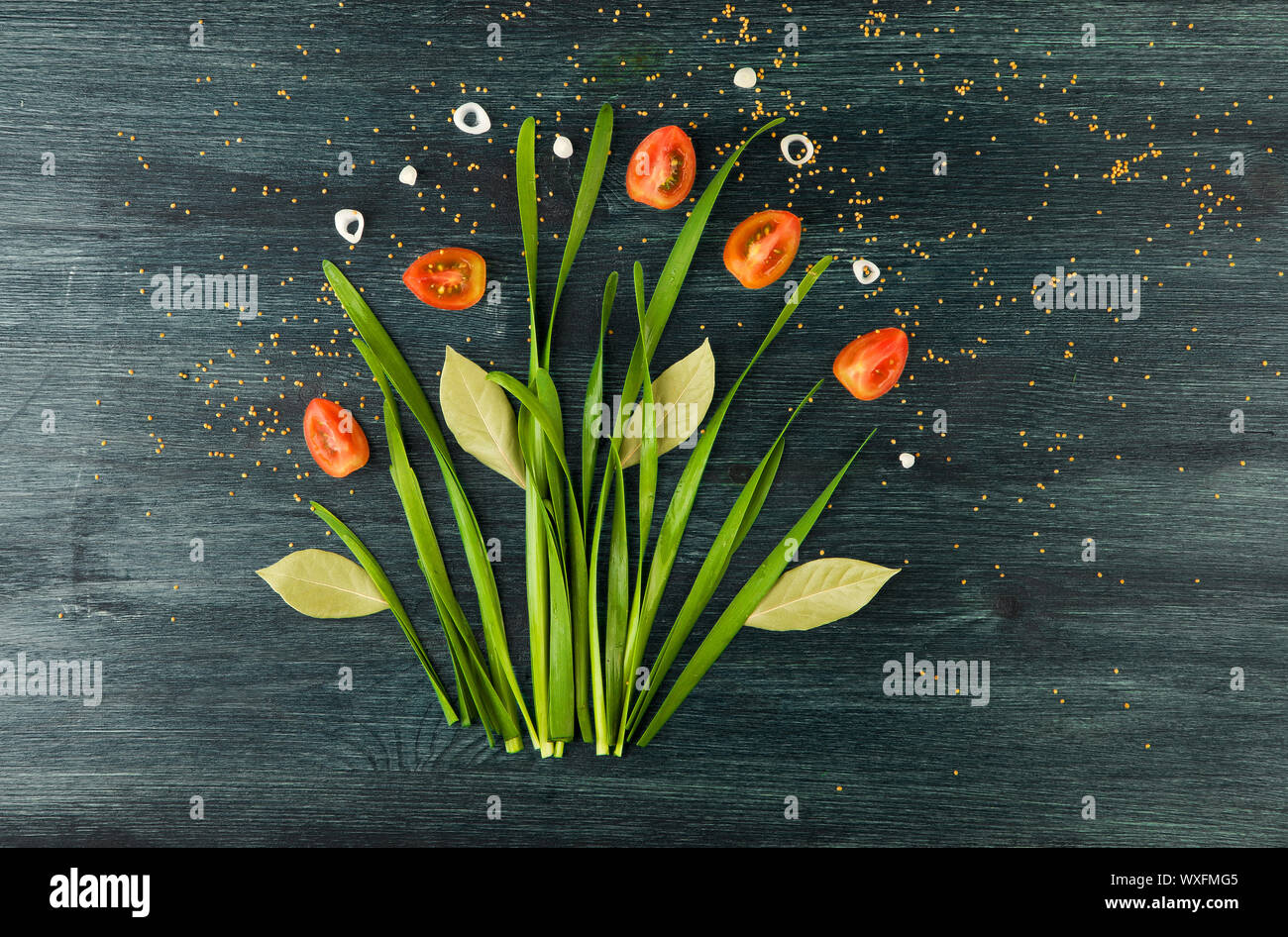 BOW ON THE BACKGROUND. GREEN BOW OF THE ONIONS, WHITE ONIONS AND TOMATO ...