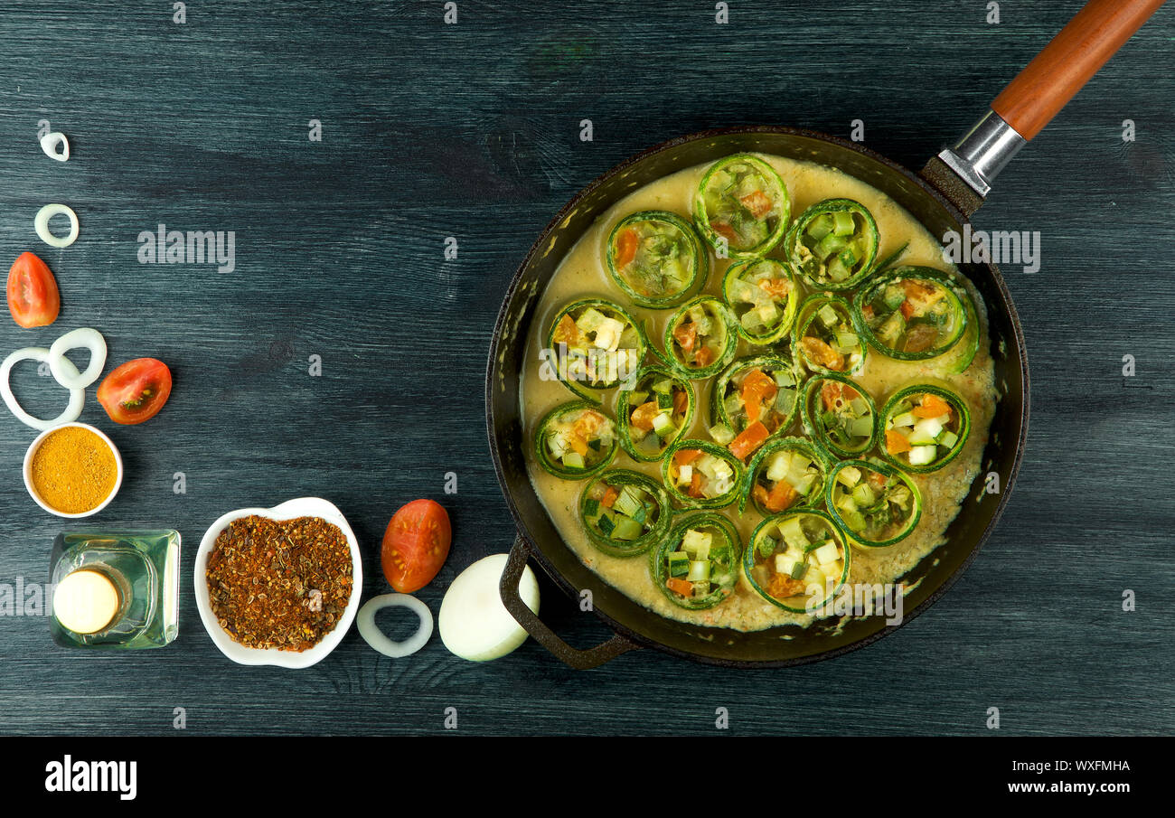 Zucchini in the background. Fried young sliced courgettes in a pan on a ...