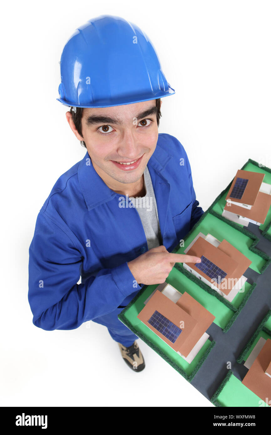 Worker pointing at scale model of housing Stock Photo - Alamy
