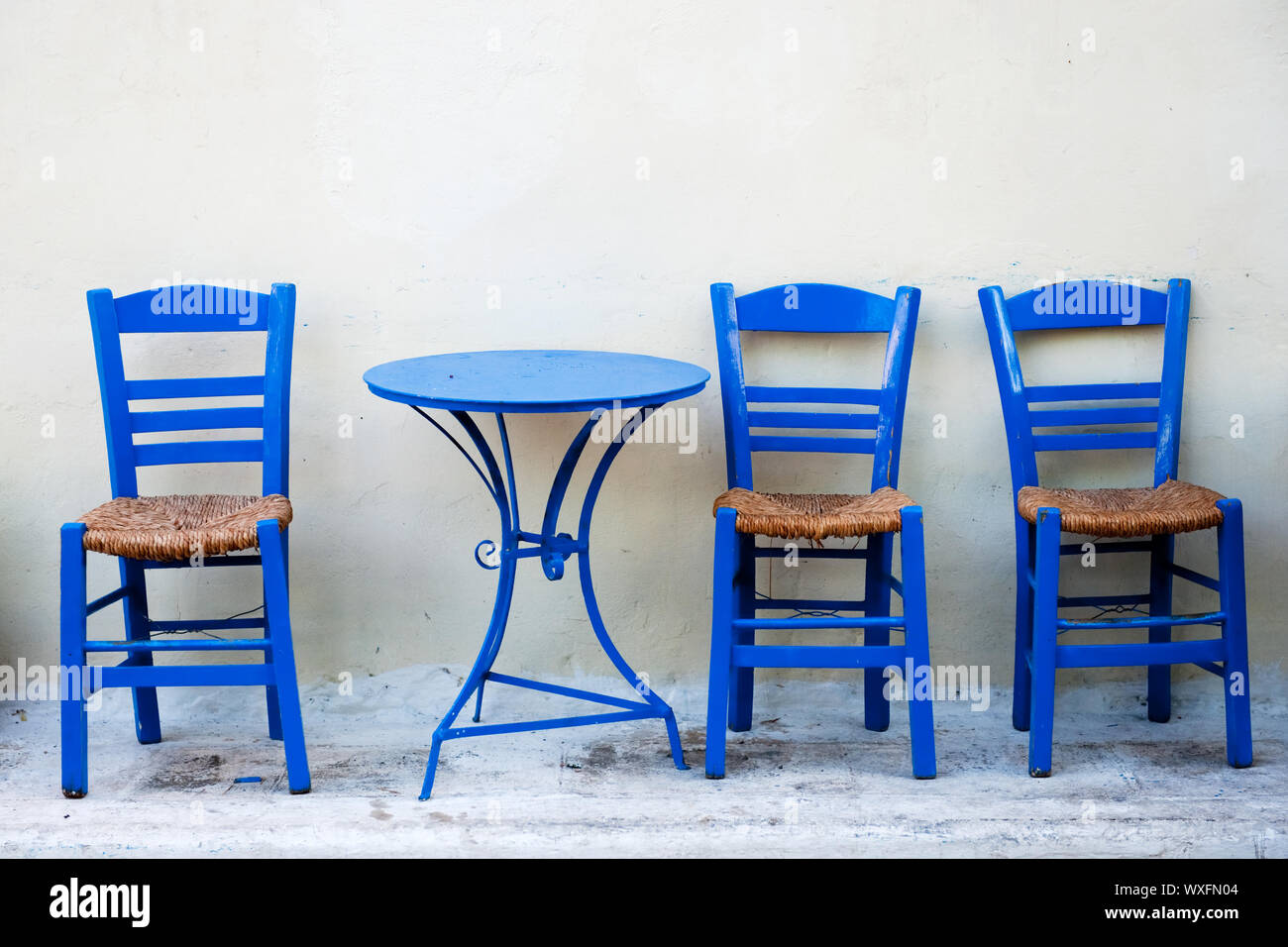 Traditional Greek terrace with blue tables and chairs Stock Photo - Alamy