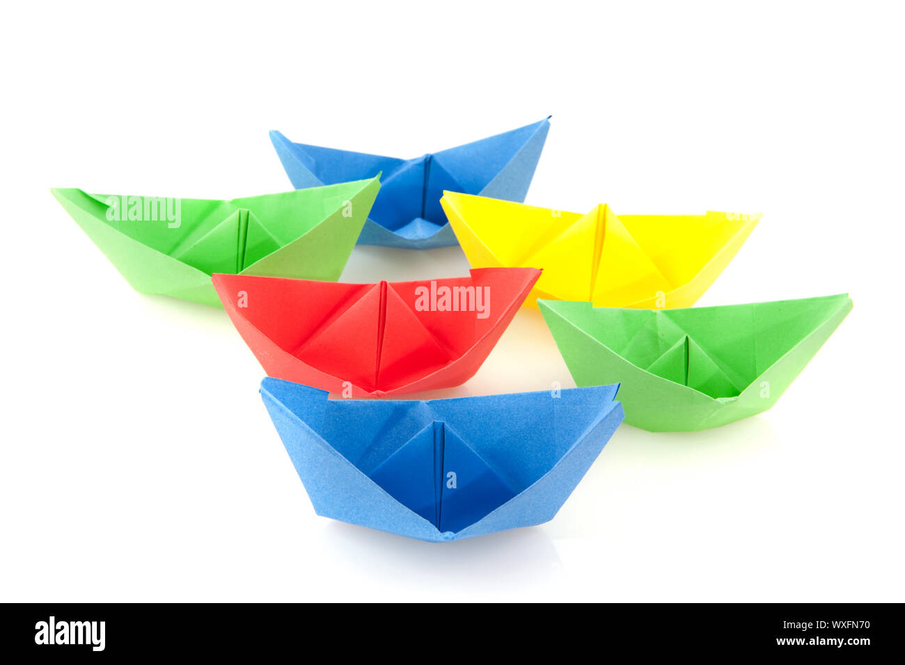 many colorful folded paper boats on white background Stock Photo - Alamy