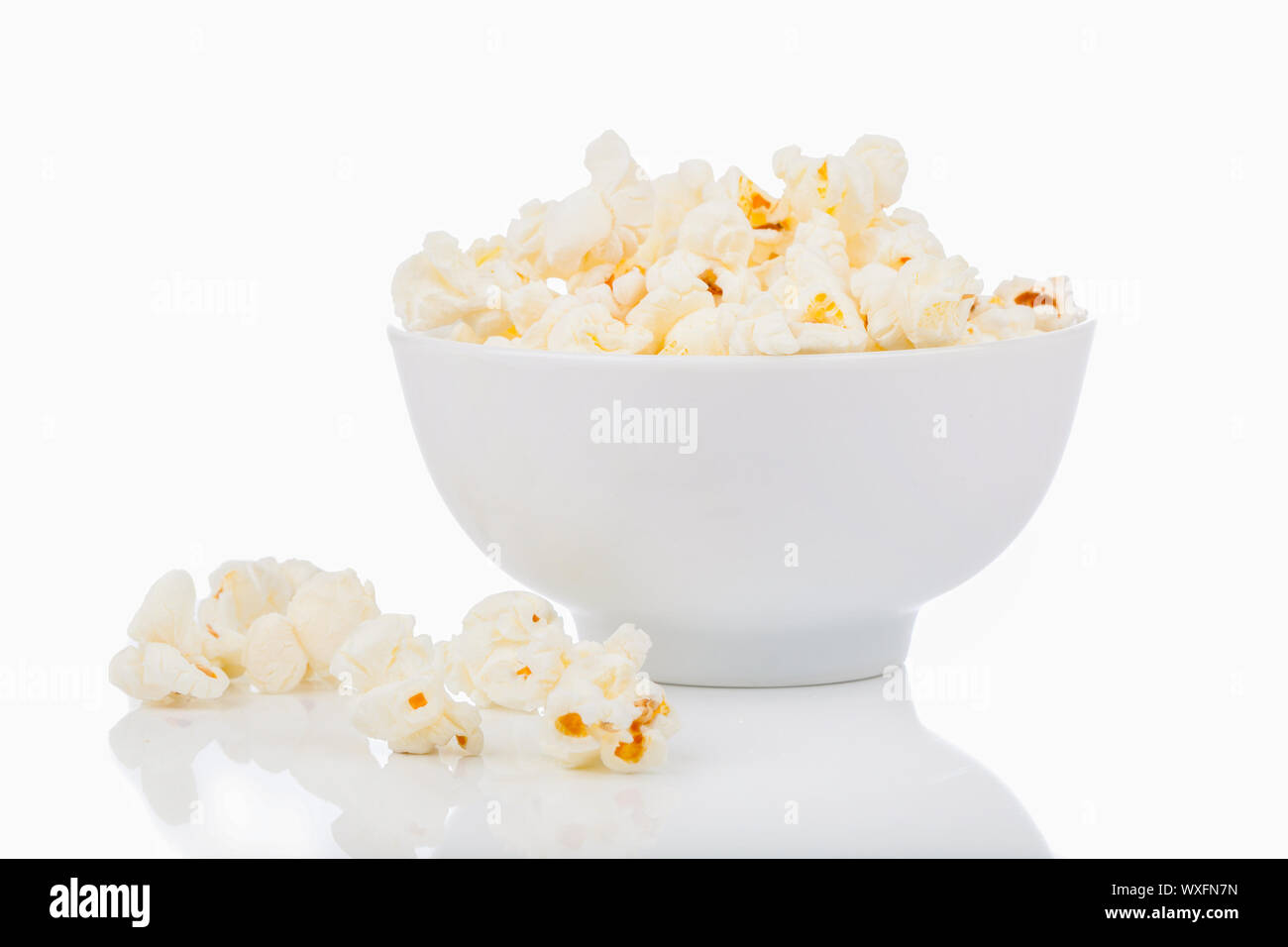 Popcorn in a bowl, isolated on white Stock Photo - Alamy