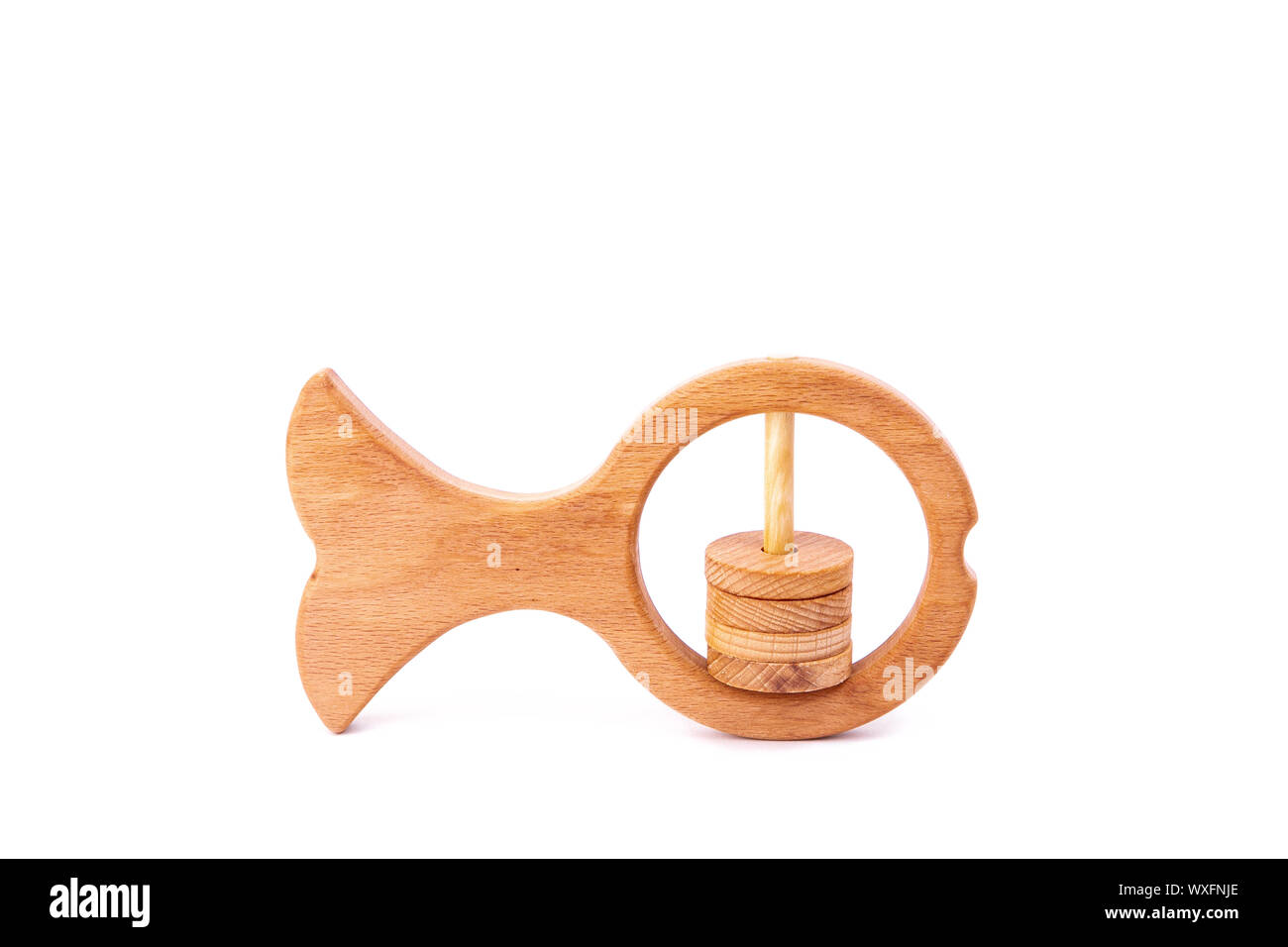 Photo of wooden rattles in the shape of a fish on a white isolated ...