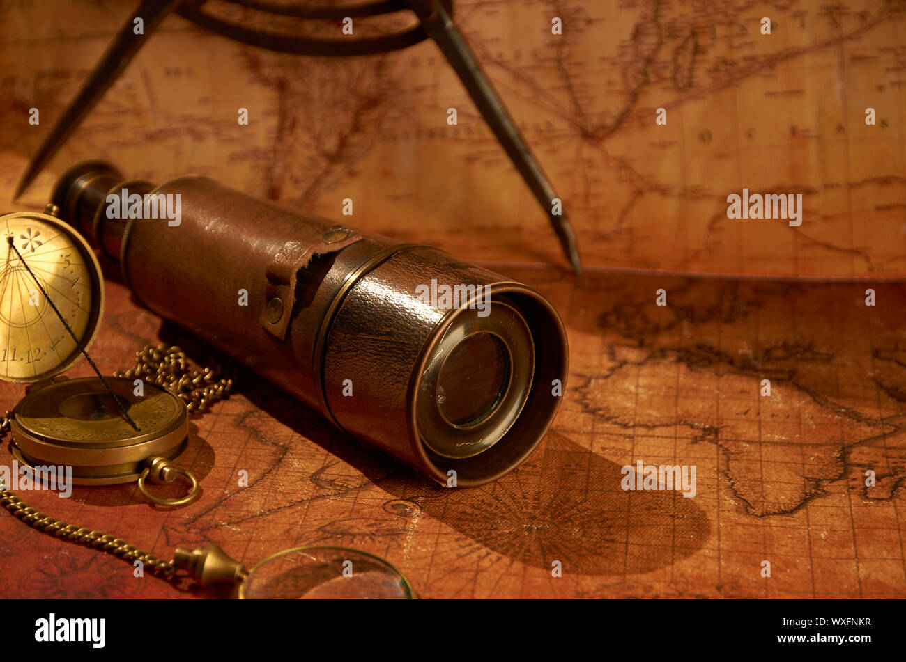 Telescope with compass on the background of the old map Stock Photo - Alamy