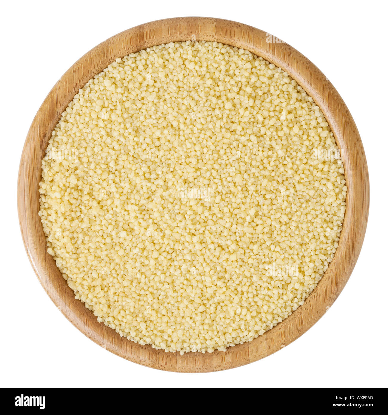 Uncooked couscous in wooden bowl isolated on white background with ...