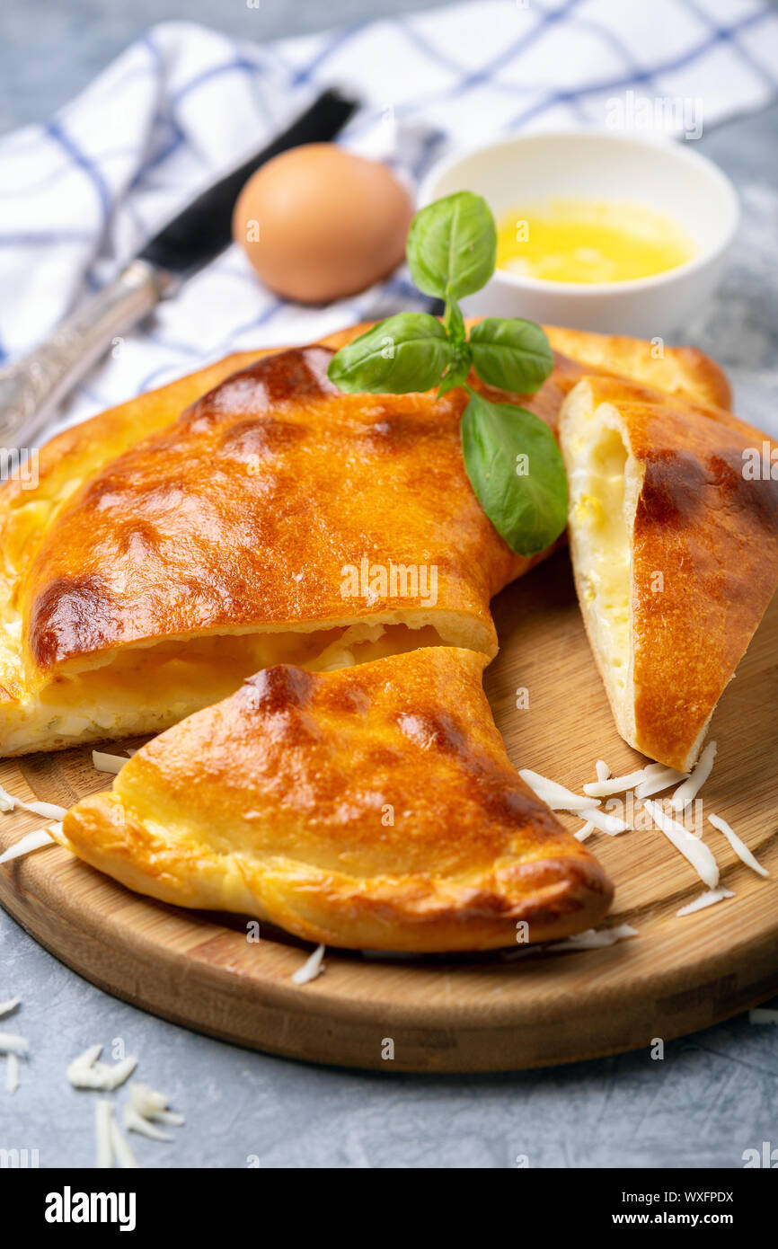 Cut closed pie with cheese and egg (khachapuri Stock Photo - Alamy