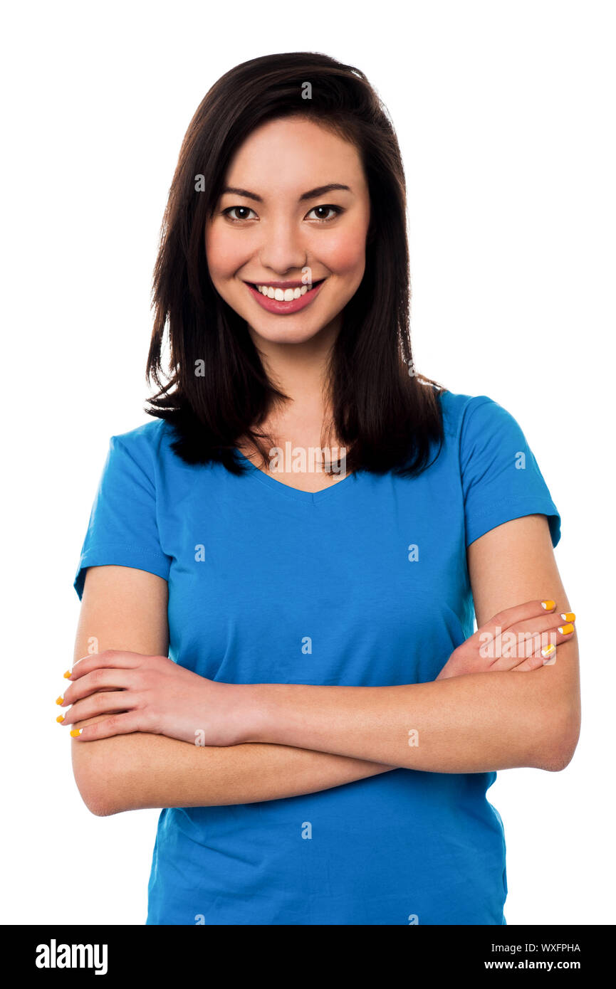 Attractive young woman with a radiant smile, arms crossed Stock Photo ...