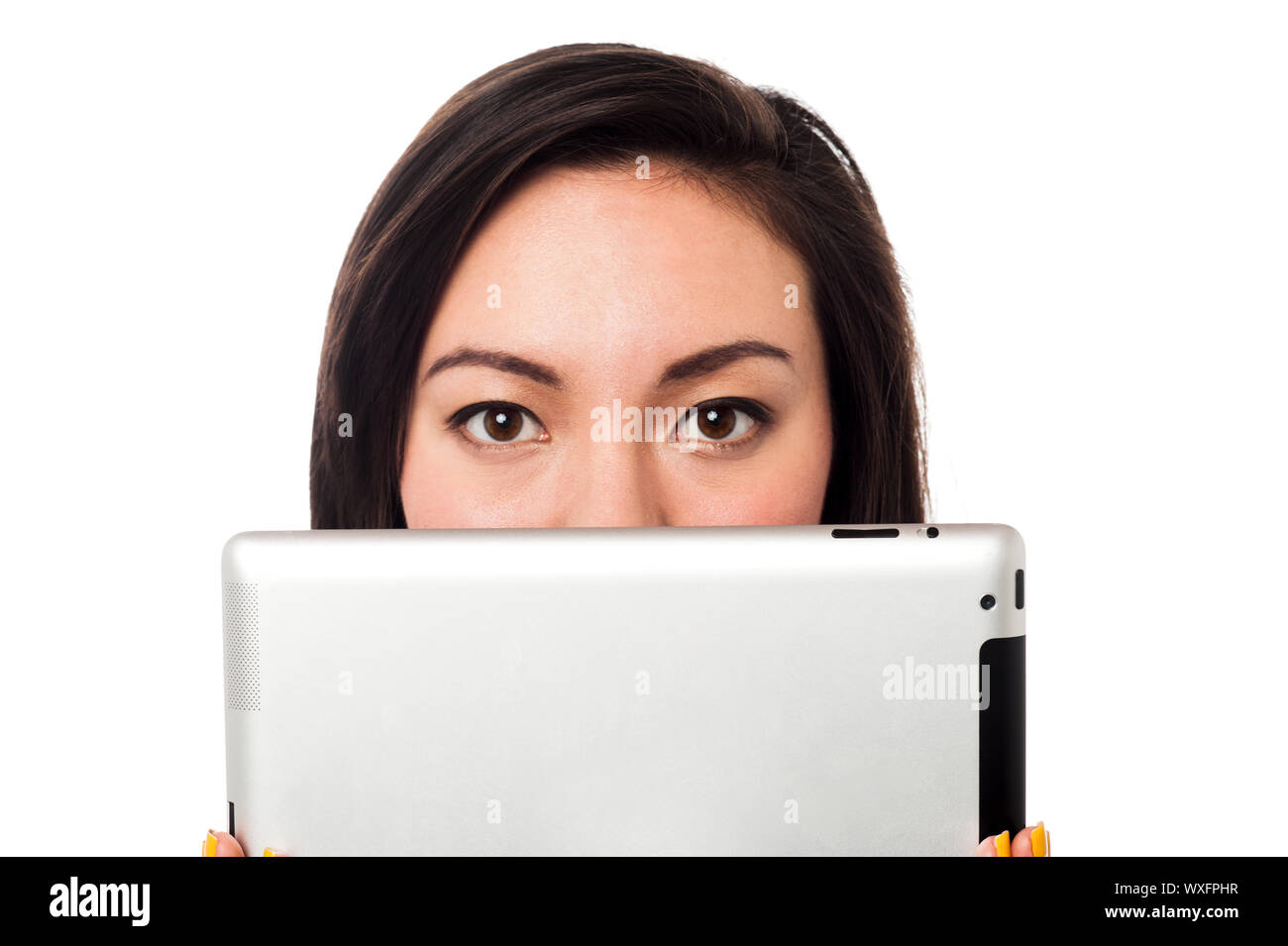 Young girl hiding her face with touch pad Stock Photo - Alamy