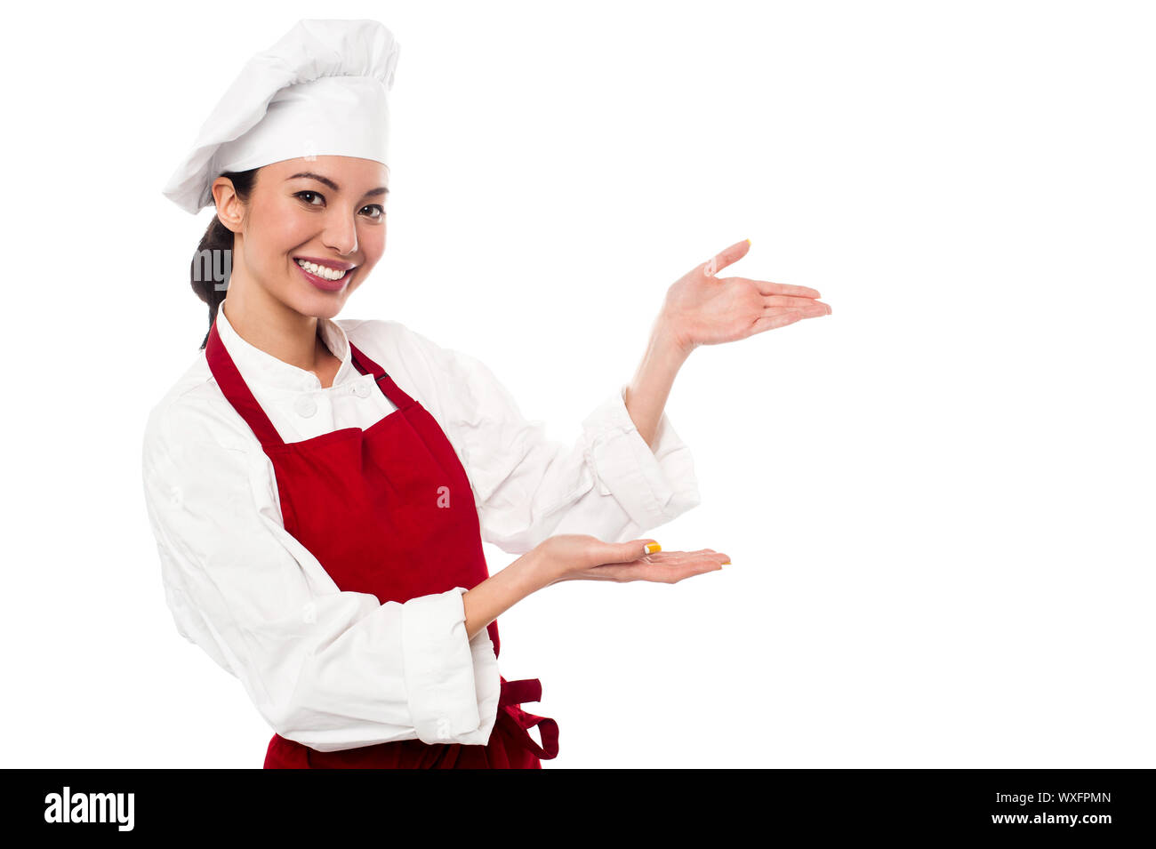 Pretty cook greeting the customers and directing them the way Stock ...