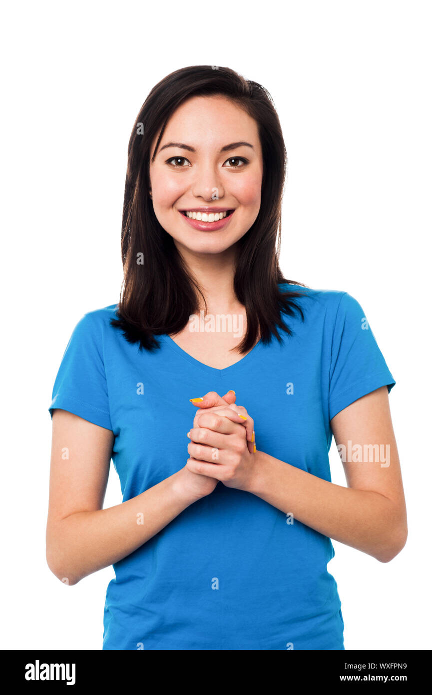 Pretty young girl posing with clasped hands isolated on white Stock ...