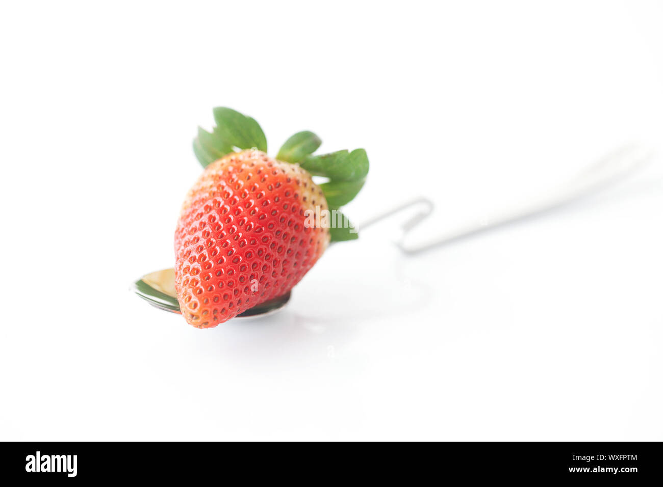 big red strawberry and spoon isolated on white Stock Photo - Alamy