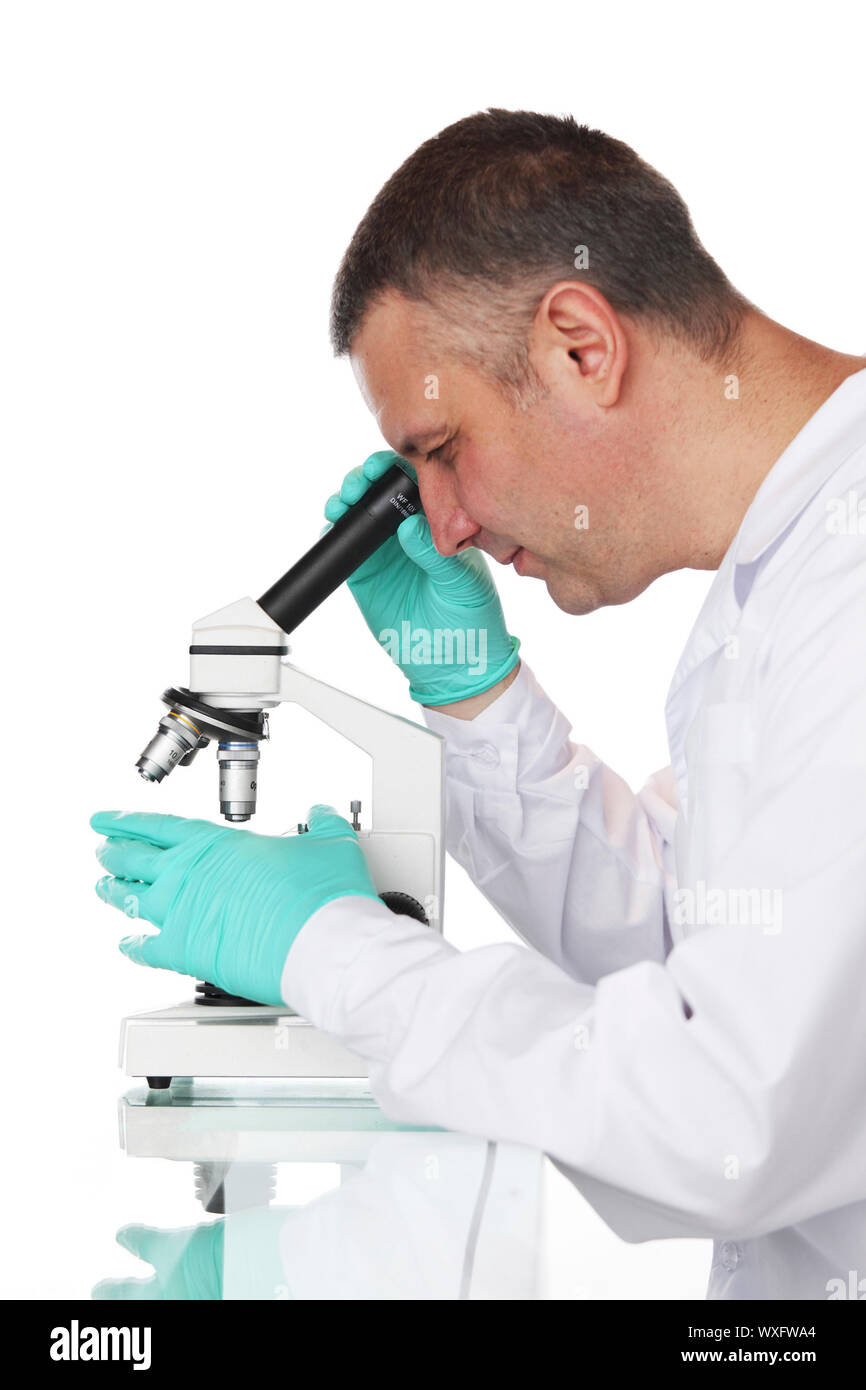 Scientist looking into a microscope in a laboratory Stock Photo - Alamy
