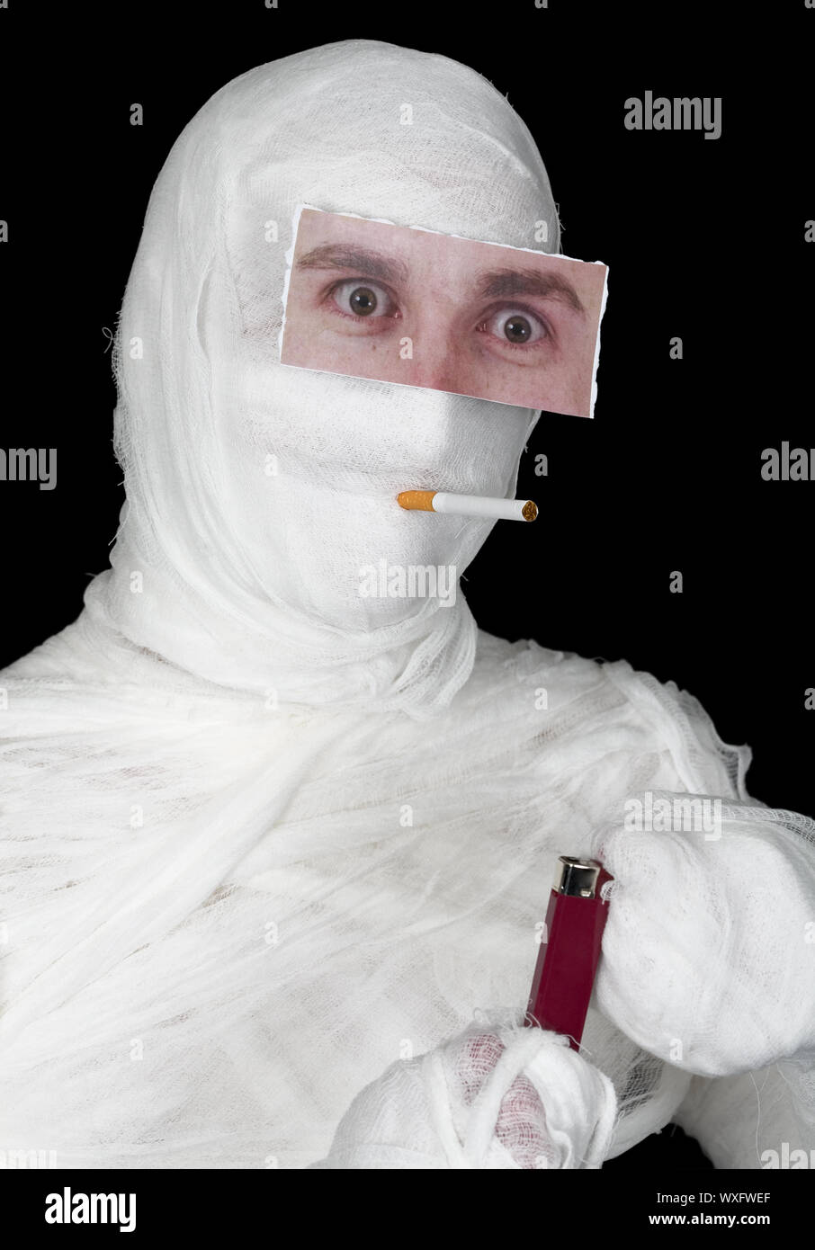 Mummy with false eye and lighter on the black background Stock Photo ...