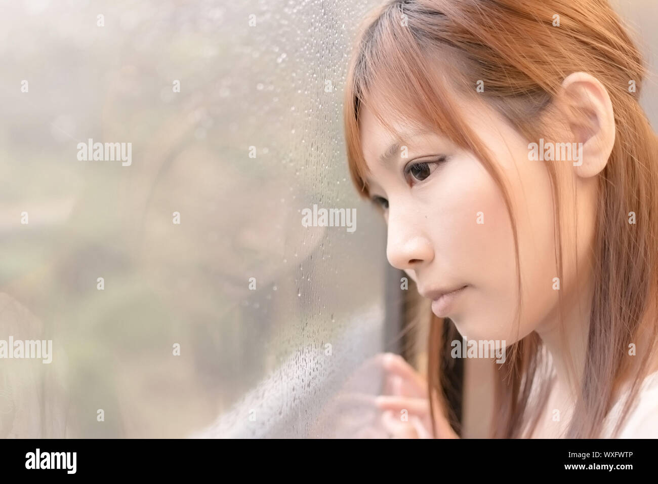 Asian beauty in MRT carriages look through the window into far away ...