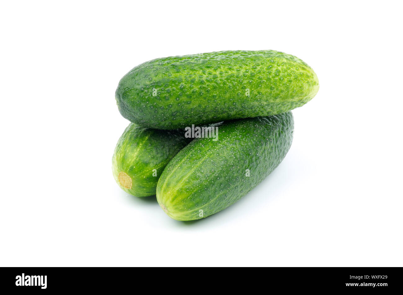 Stack of Perfect Raw Cucumbers isolated on white background Stock Photo ...
