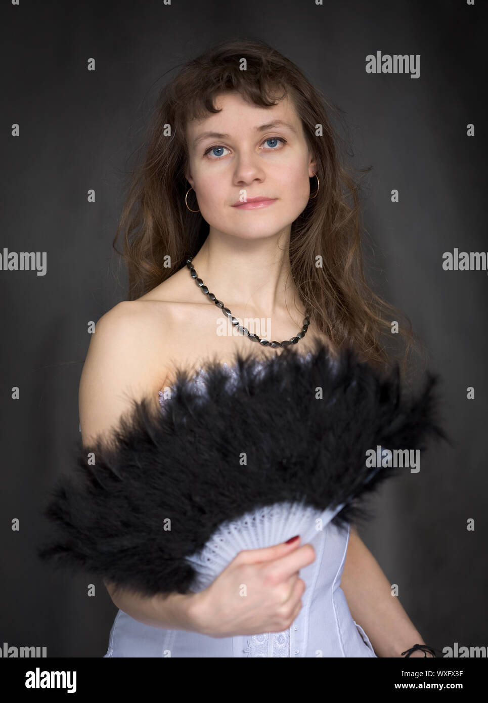 Portrait of the girl with a fan in hand Stock Photo - Alamy