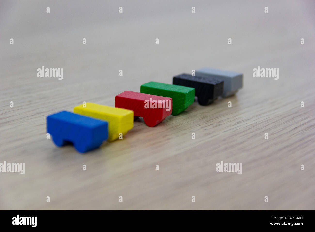 different colored game pieces representing different cars, concept of ...