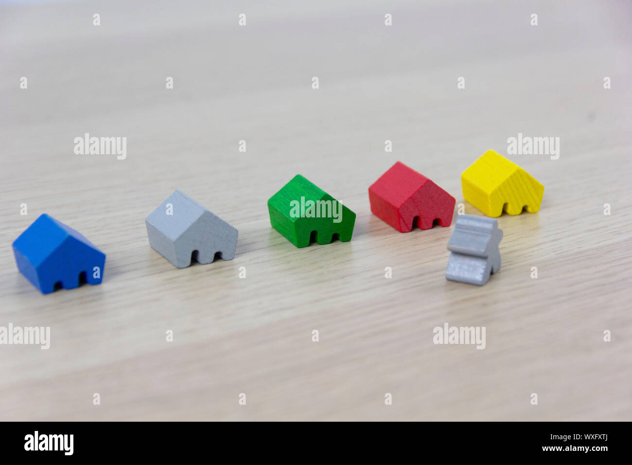 different colored game pieces representing different houses, concept of ...