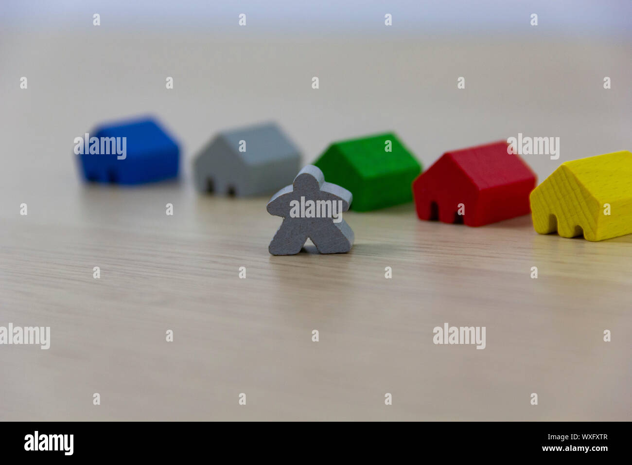 different colored game pieces representing different houses, concept of ...