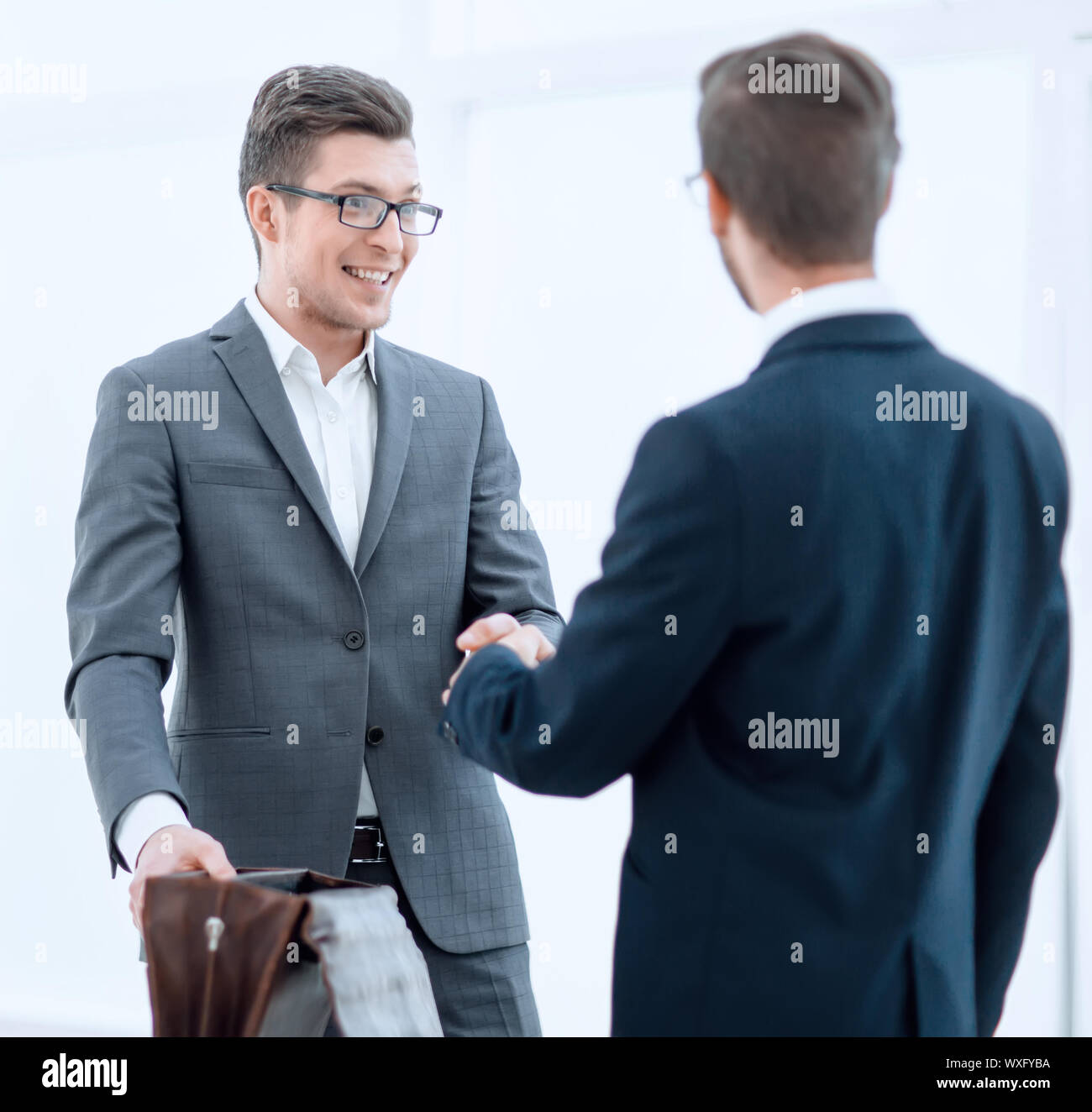 business people greet each other with a handshake Stock Photo - Alamy