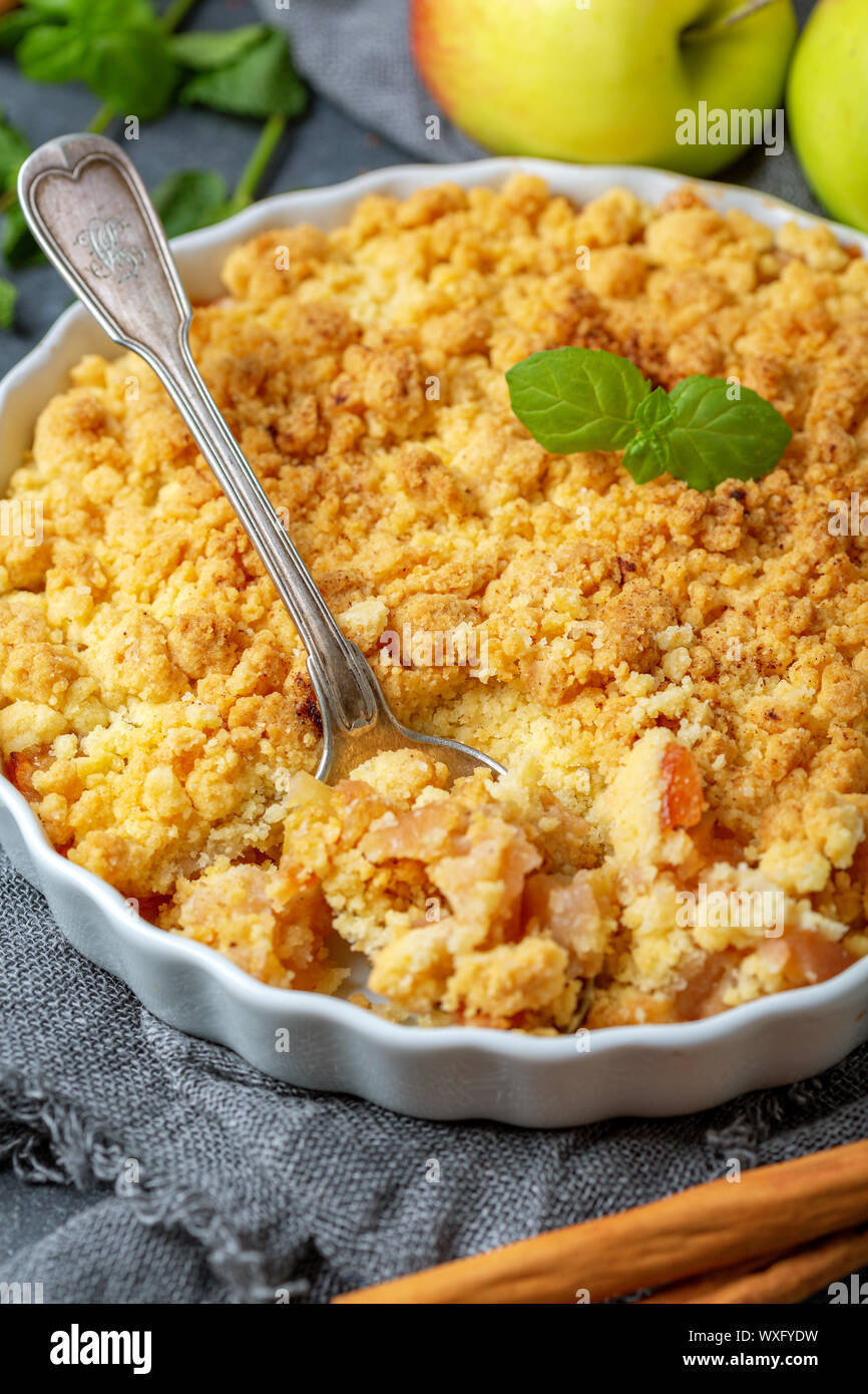 Apple crumble and a dessert spoon closeup Stock Photo - Alamy