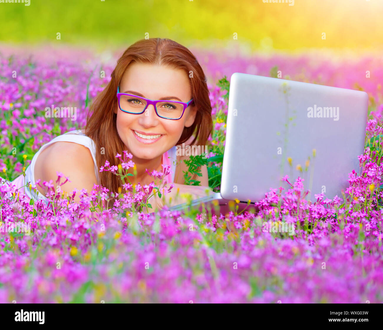 Cute girl with laptop outdoor Stock Photo - Alamy
