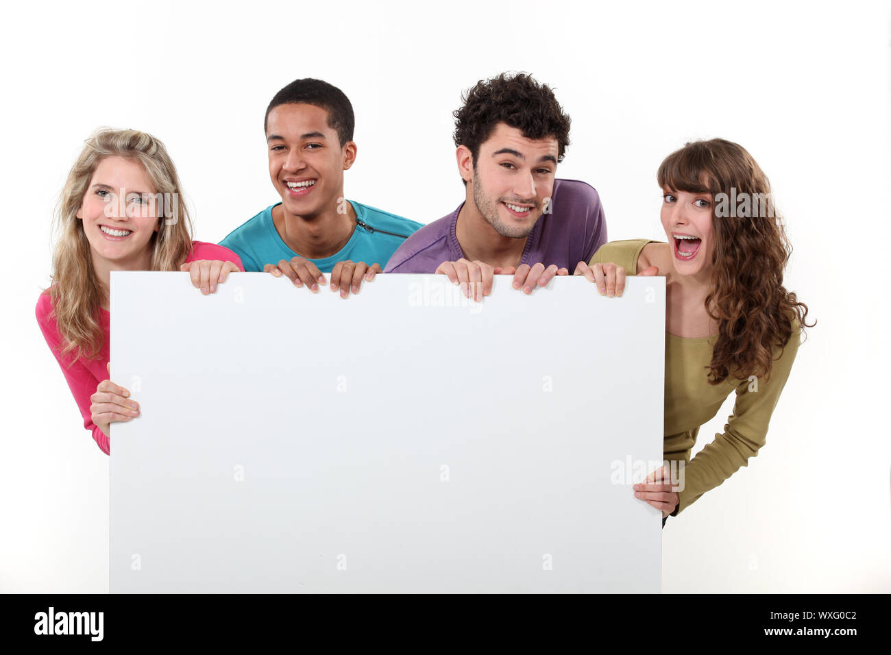 group of friends holding a blank poster Stock Photo - Alamy