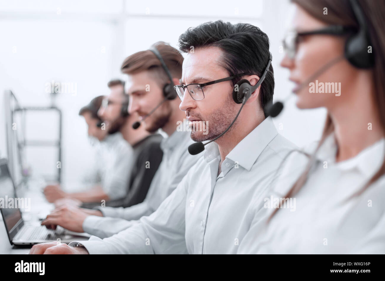 close up.background image of call center employees in the workplace ...