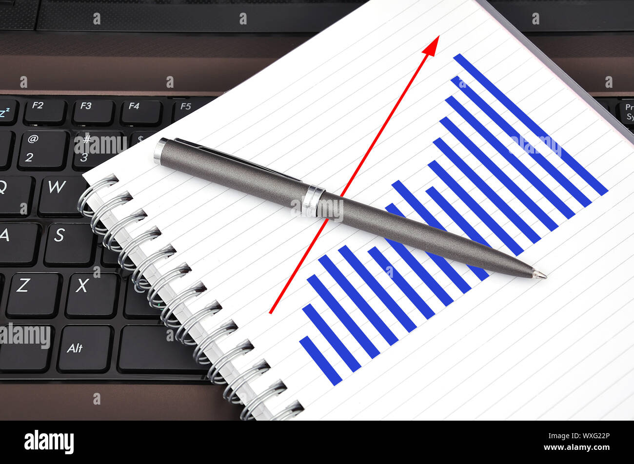 drawing chart in notebook and laptop Stock Photo - Alamy