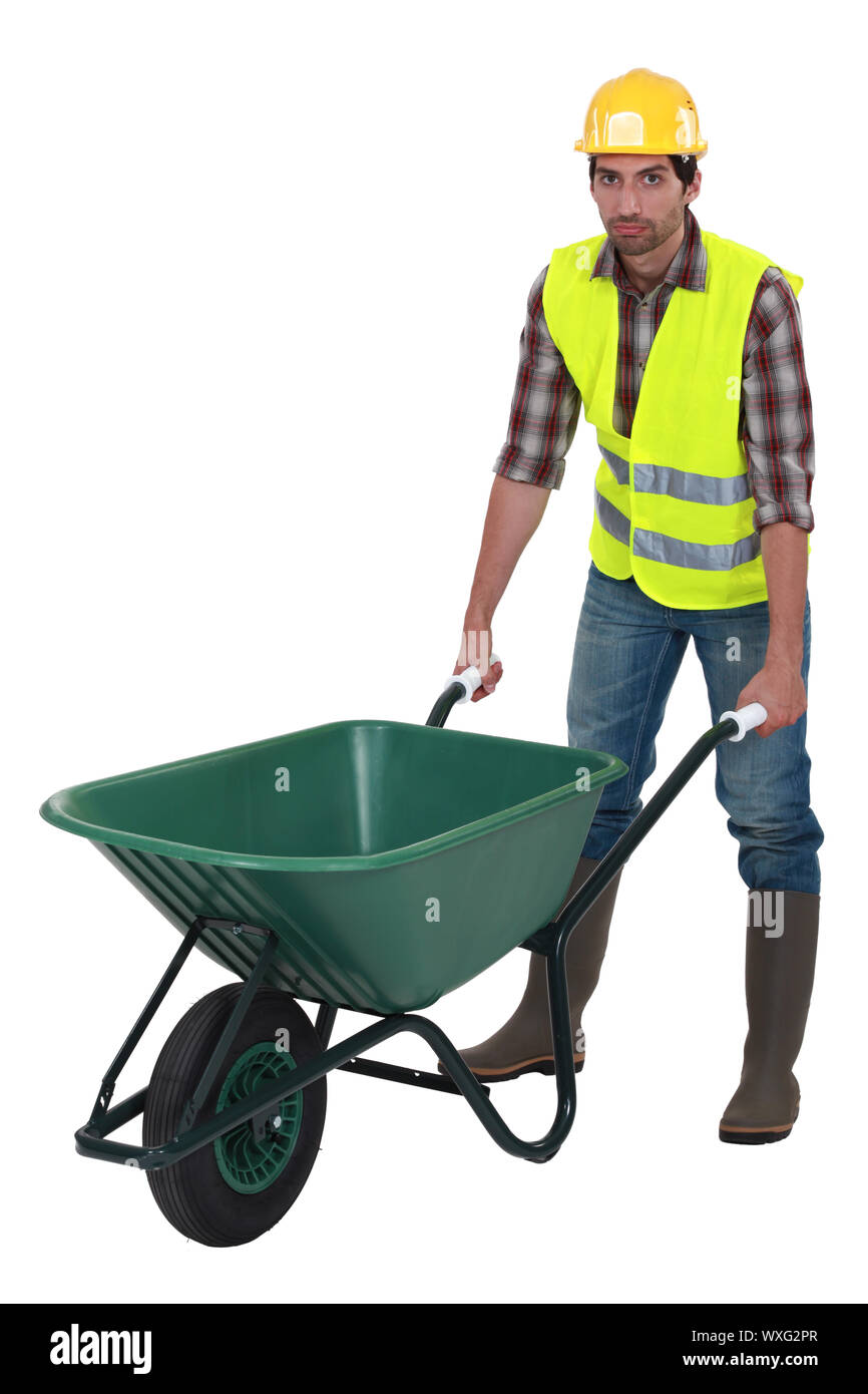 Construction Worker Pushing A Wheelbarrow High Resolution Stock ...