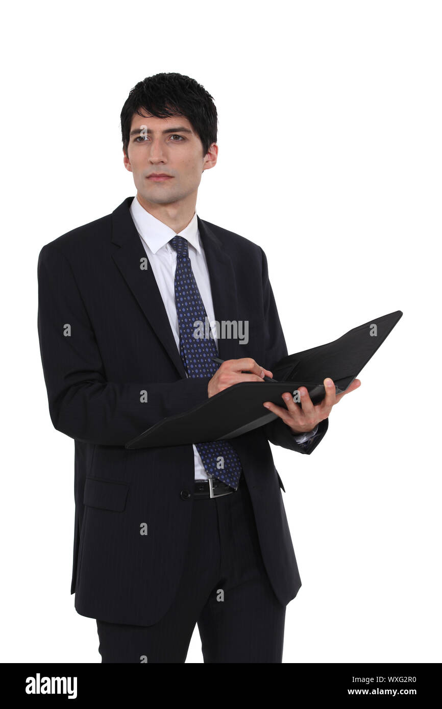 Man writing in business document folder Stock Photo - Alamy