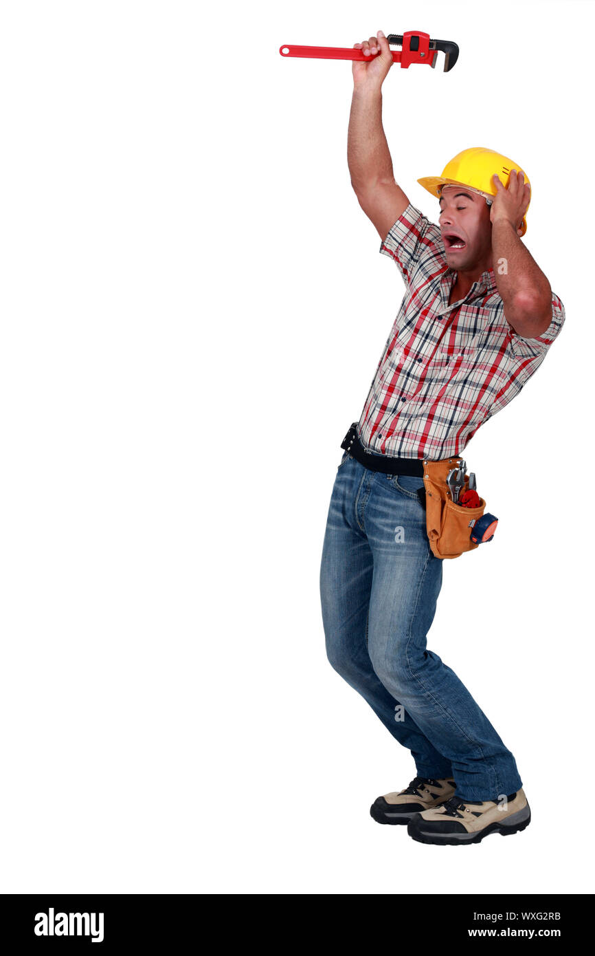 Plumber gesturing on white background Stock Photo - Alamy