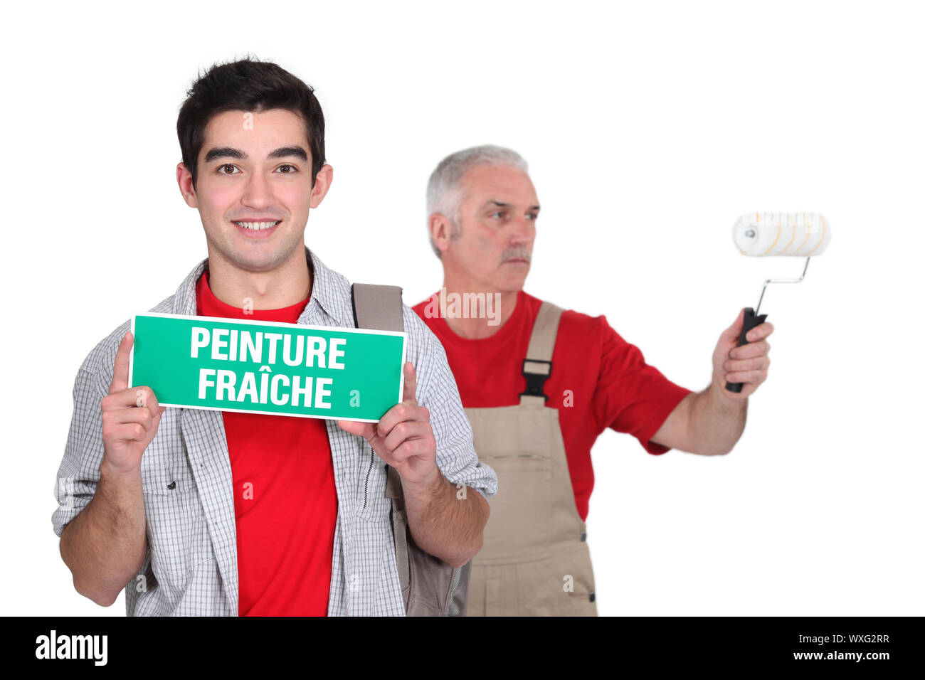 Two main painting with roller Stock Photo - Alamy