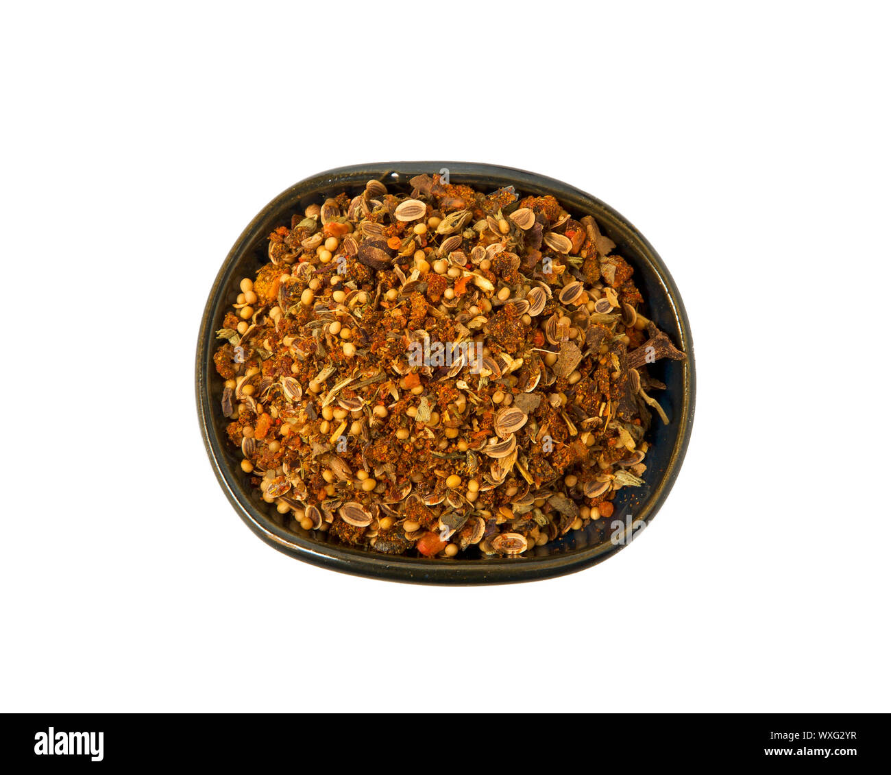 A mixture of seasonings in a bowl isolated on a white background. Spice ...