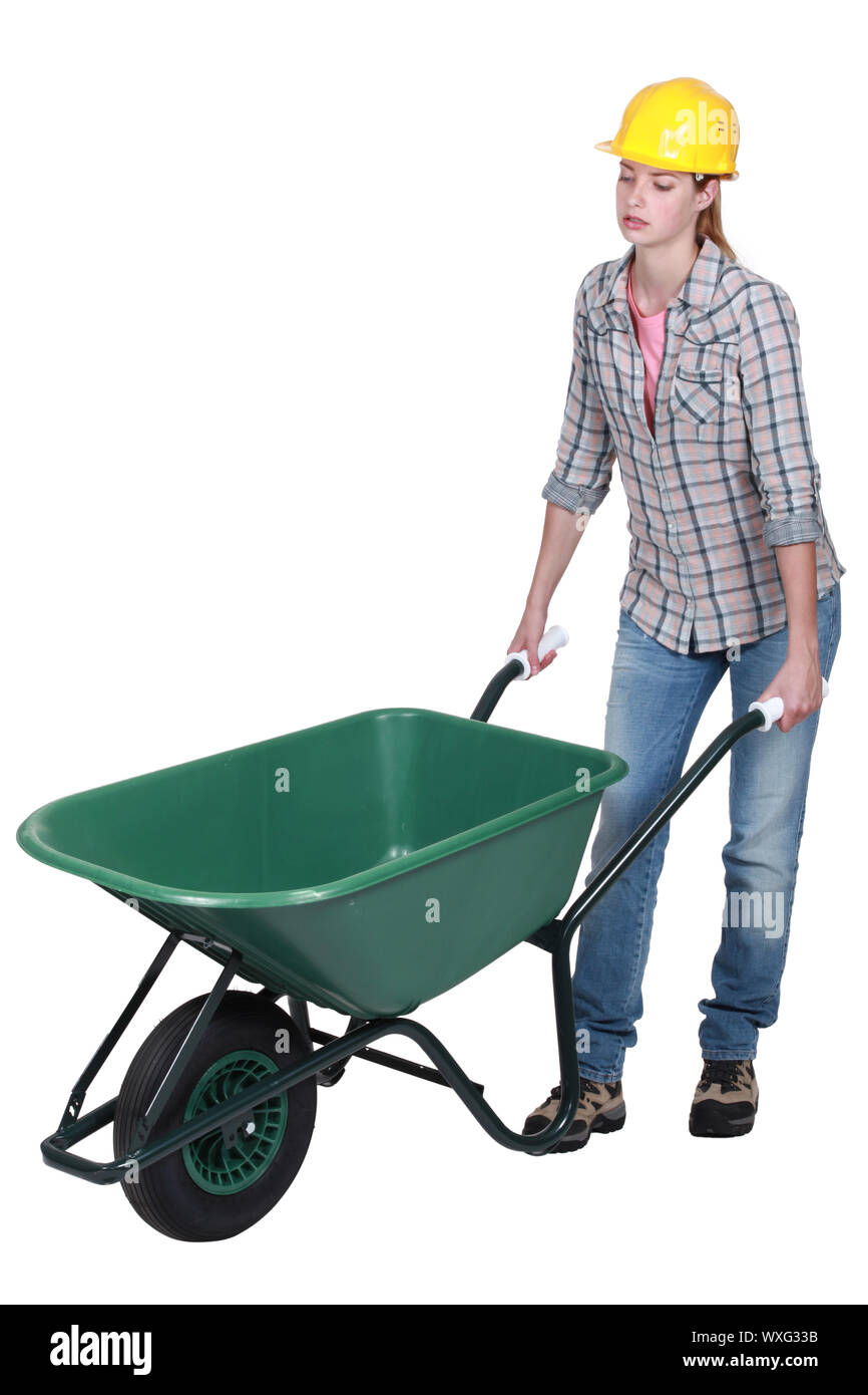 Woman pushing empty wheelbarrow Stock Photo - Alamy