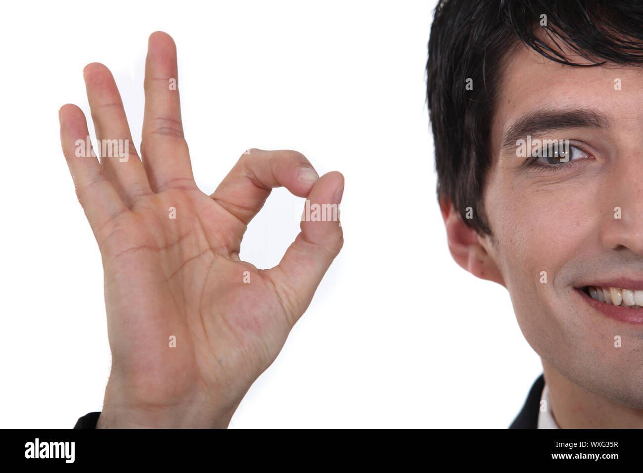 Man giving the a-ok hand gesture Stock Photo - Alamy