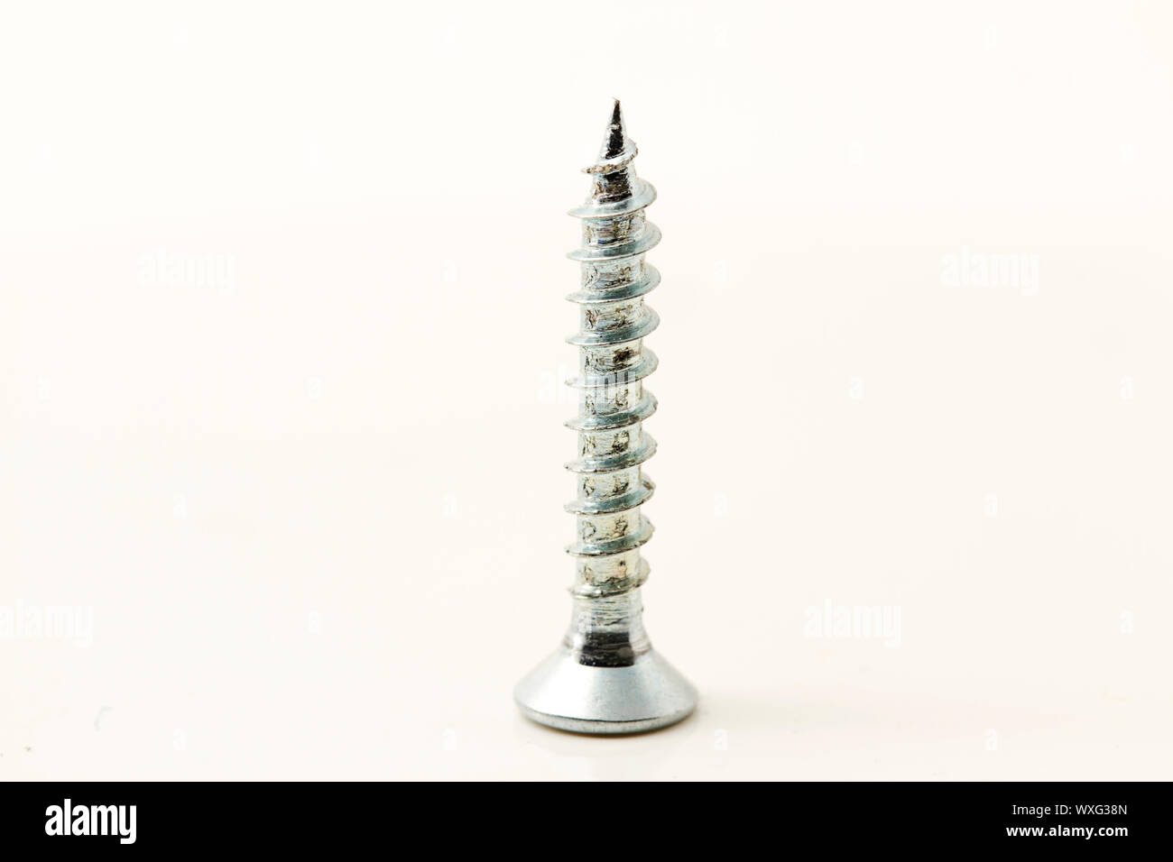 one small screw isolated on white background Stock Photo - Alamy
