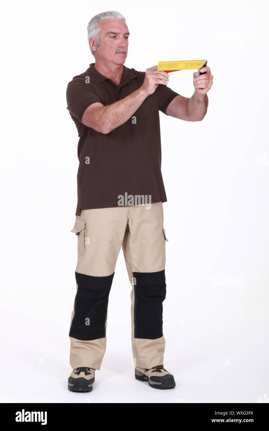 Man holding a try square Stock Photo - Alamy