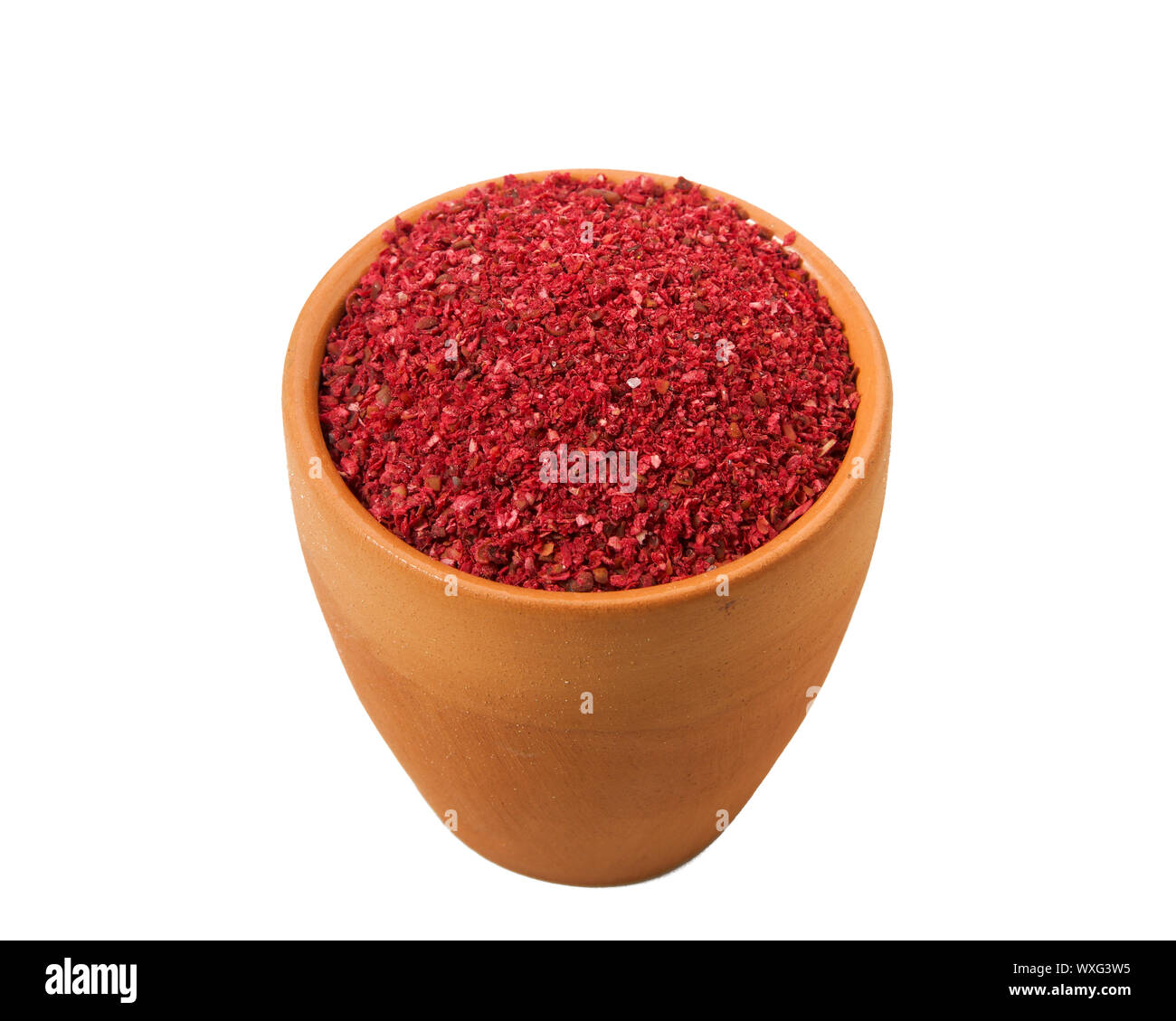 Ground red pepper in a bowl isolated on a white background. View from ...