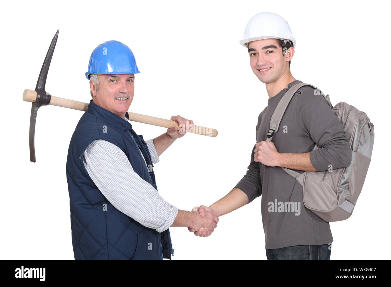 Laborer welcoming young teenage apprentice Stock Photo - Alamy