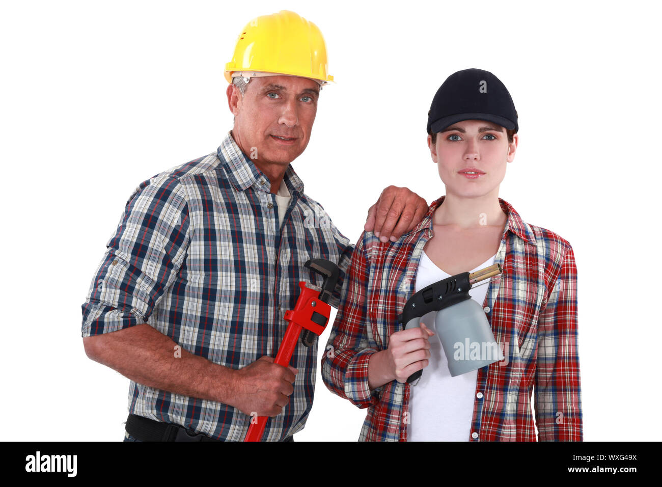 Tradespeople holding tools Stock Photo - Alamy