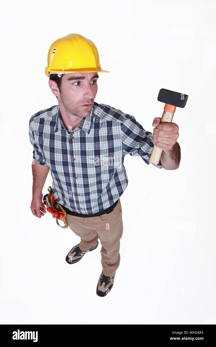 Man curiously looking at hammer Stock Photo - Alamy