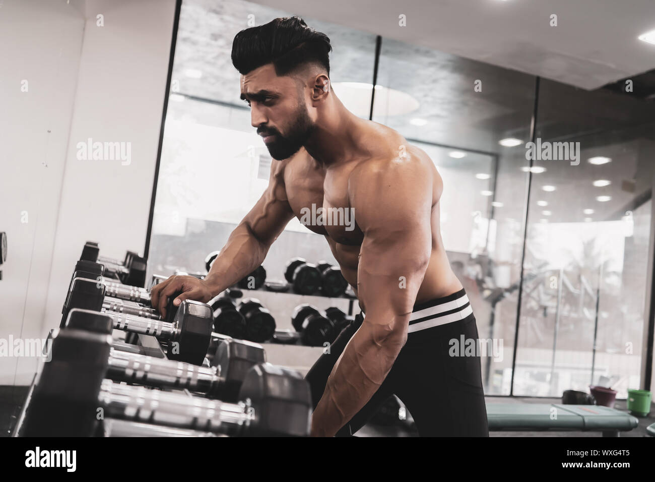 Man doing one-arm row exercise for his back Stock Photo - Alamy