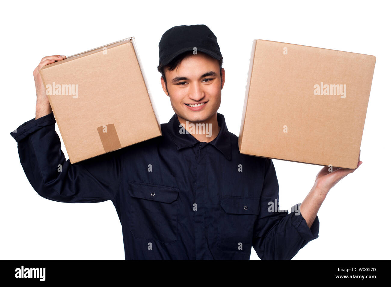 Young delivery boy at work carrying carton boxes on shoulders Stock ...