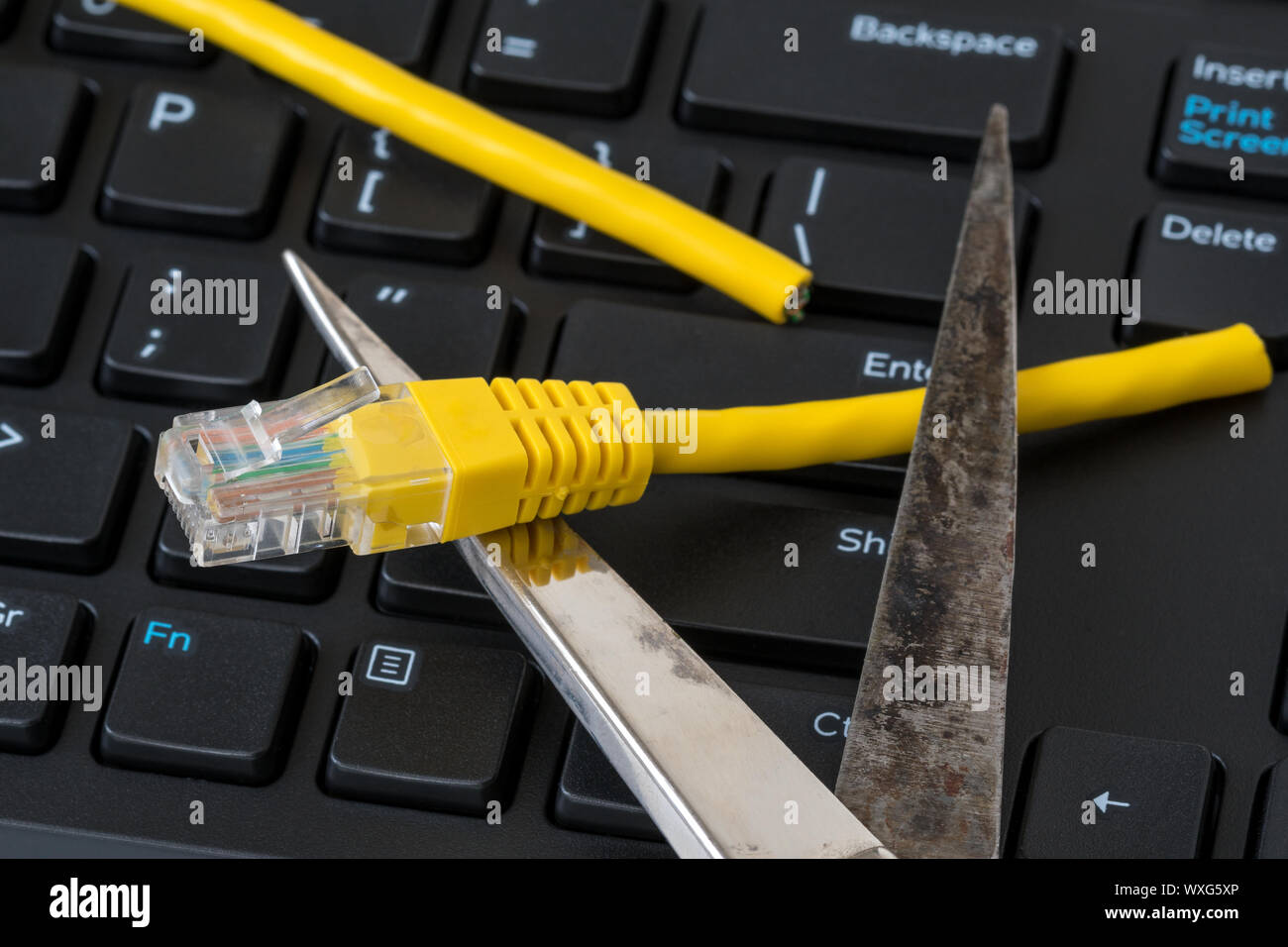 Scissors Cutting Network Cable Over Computer Keyboard Internet
